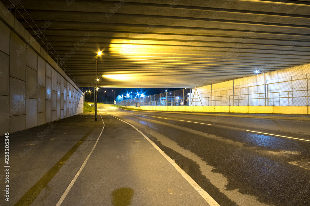 Deserted sidewalk and road underpass at night Stock Photo | Adobe Stock