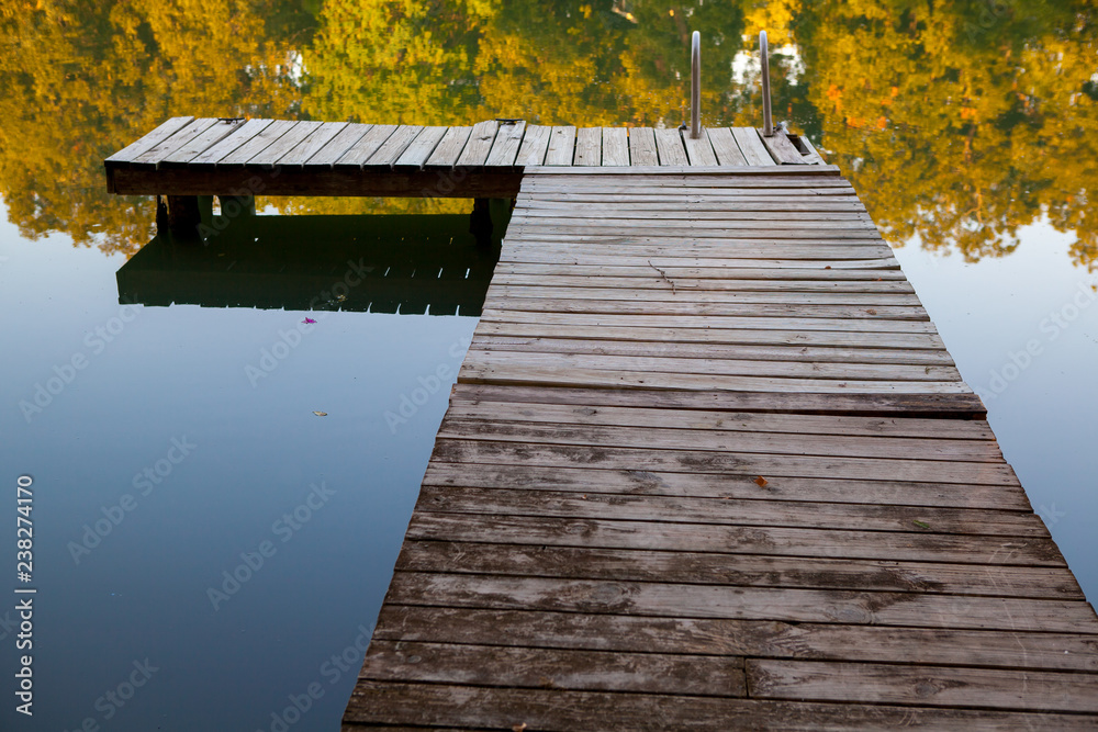 old wooden dock on lake with fall foliage in reflection Stock Photo | Adobe Stock