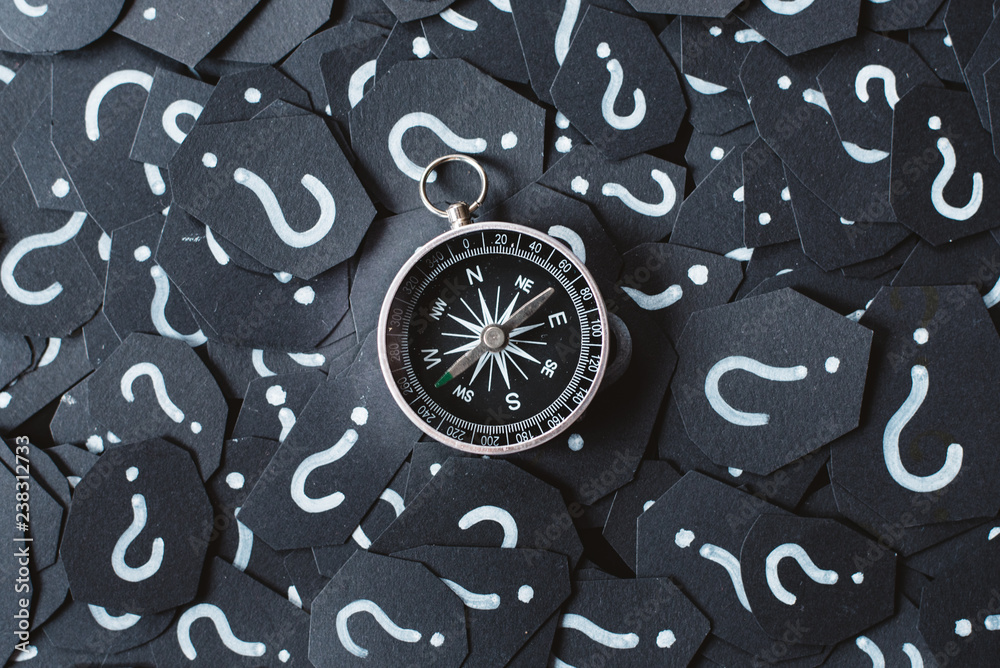 Metal compass on question mark background. Concept of travel ...