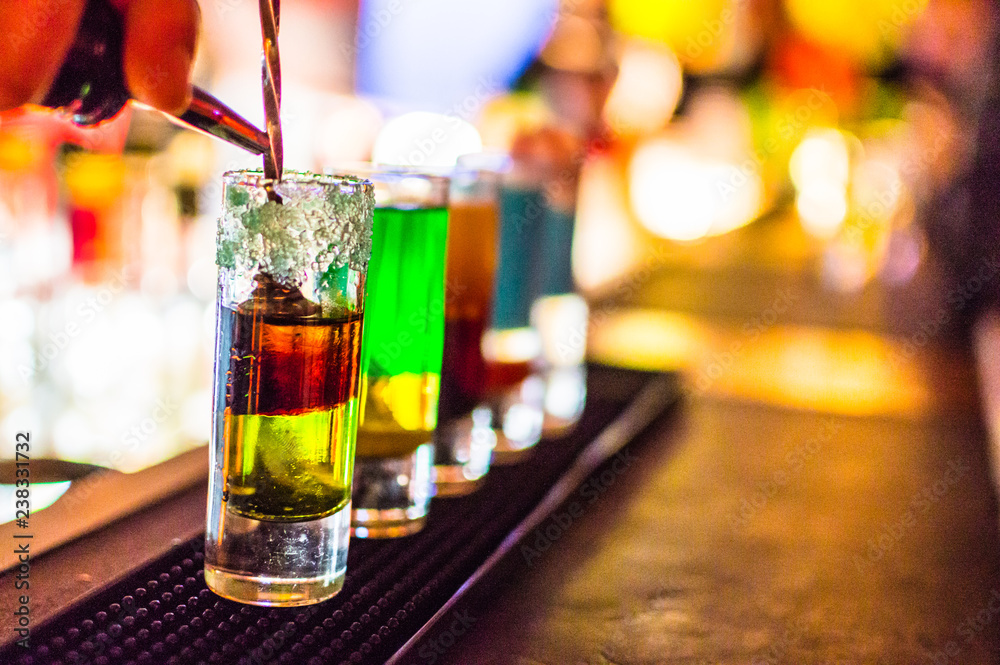 colored and beautiful Chupito drink with bokeh blurred background of an ...
