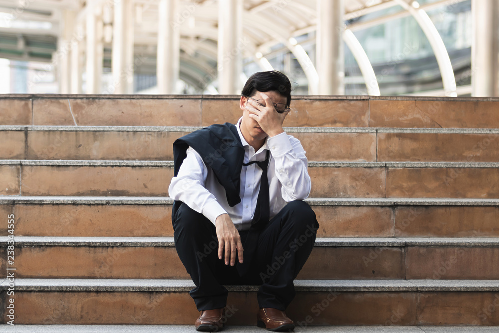 Unemployed stressed young Asian business man suffering from severe ...