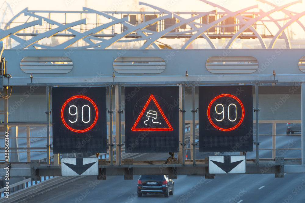 High-speed highway with traffic cars and electronic interactive speed ...
