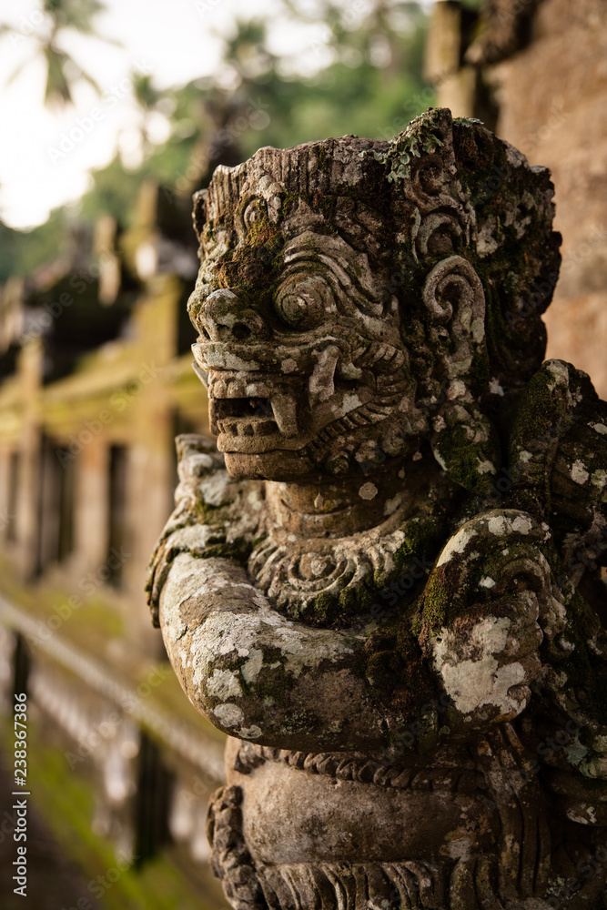 Stone carved demons protecting the staircase entrance of Pura Kehen ...
