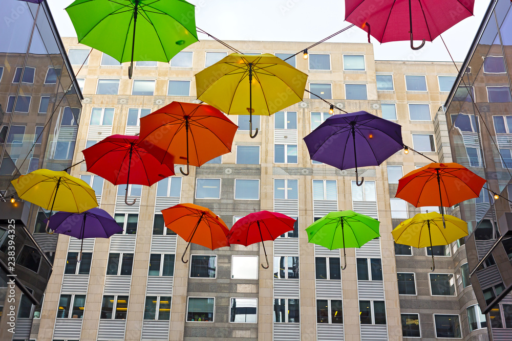 Colorful umbrellas flying between two buildings in Washington DC ...