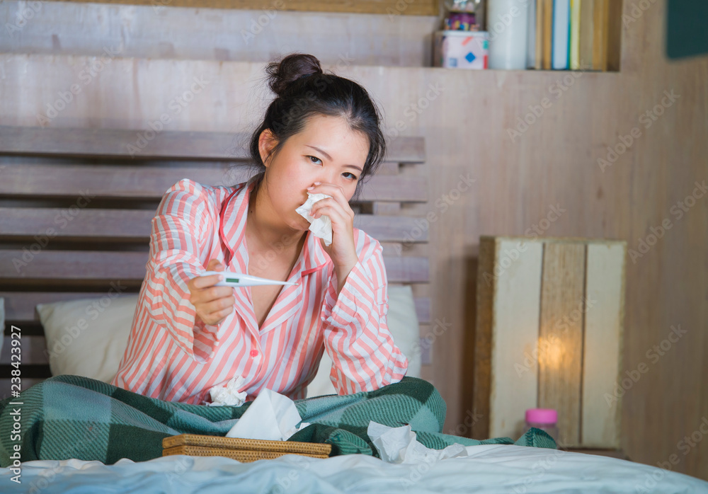 sweet Asian Japanese girl in pajamas sick at home bedroom suffering ...