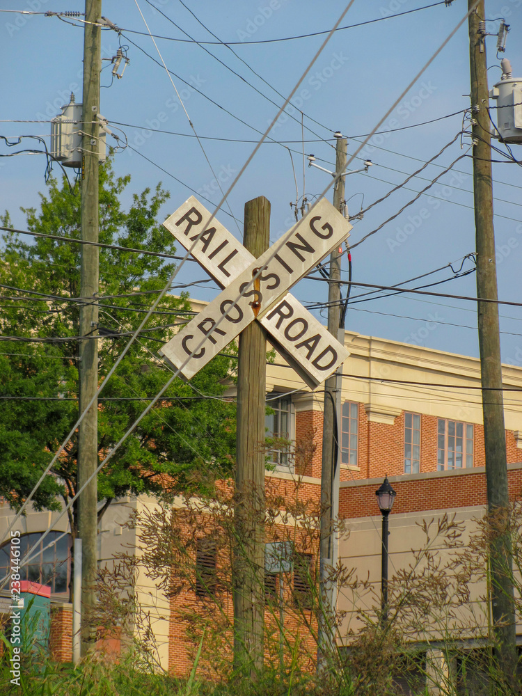 railroad crossing sign against a busy background of crossed wires and ...