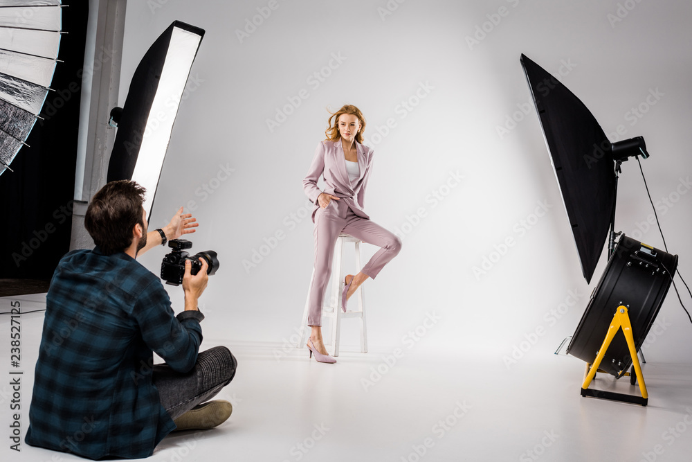 young photographer shooting beautiful stylish young woman in photo ...