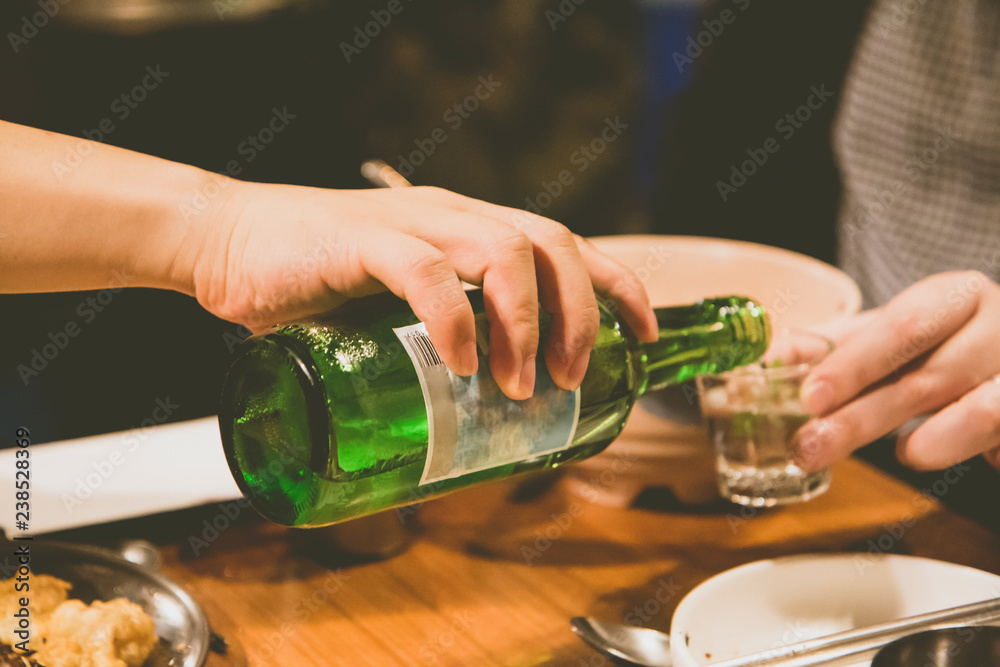 alcohol pouring from bottle in glass at the party in korea Stock Photo ...