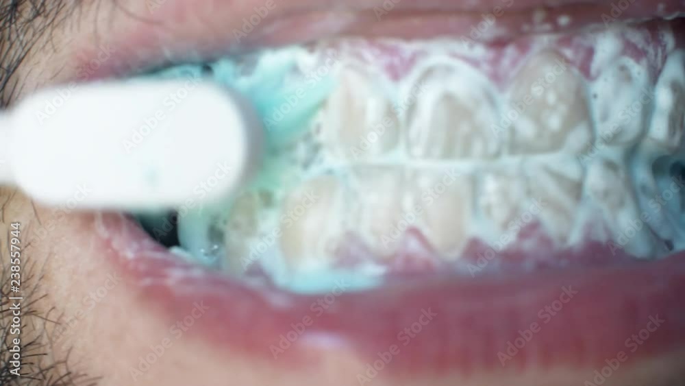 Man's open mouth and brushes his teeth in morning. Close up white man ...