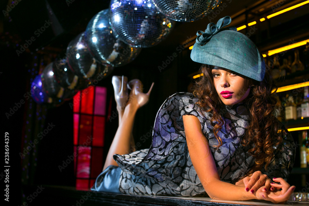 Sexy young woman lying on the bar at a night disco club Stock Photo ...