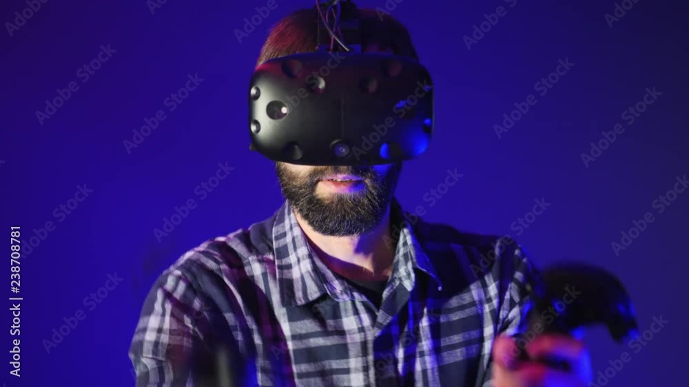 Bearded man uses VR-headset display for virtual reality at journey to ...