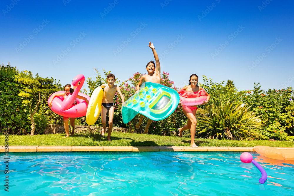 Happy children running and jumping into the pool Stock Photo | Adobe Stock