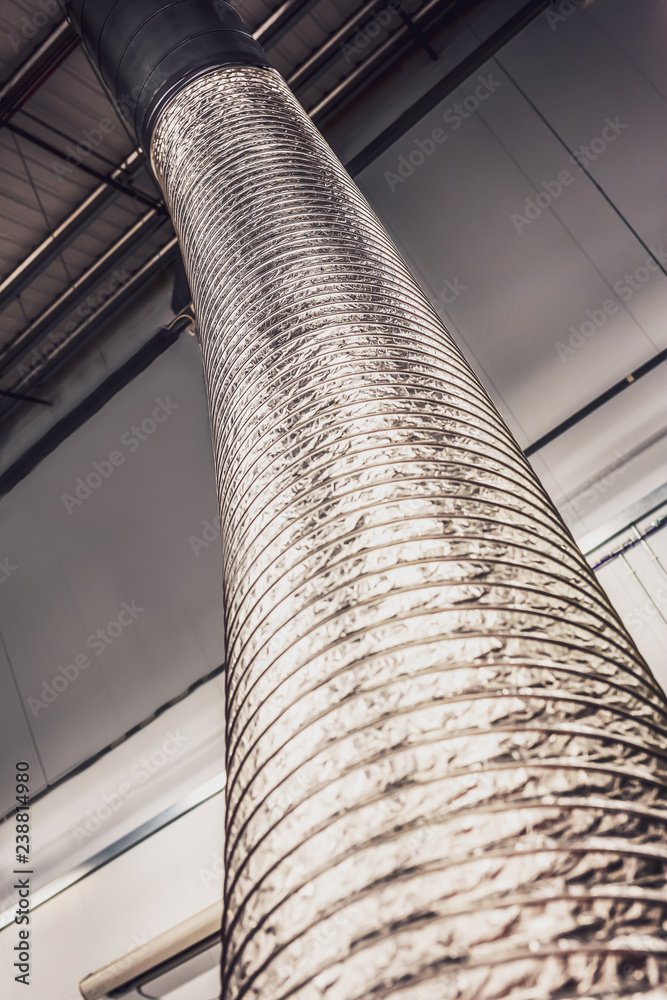expandable metallic air-conditioning ventilation pipe or tube rising up ...