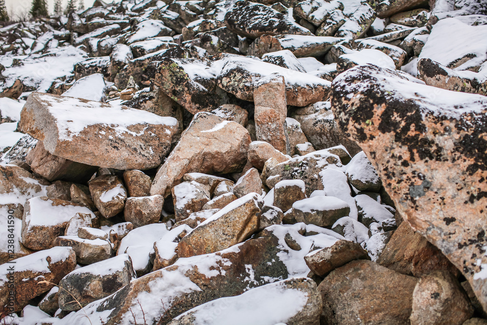 huge granite boulders stones in the snow in different shapes and sizes ...