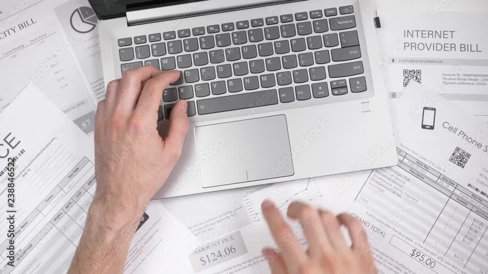 Paying bills using a laptop computer. Online utility bills payment ...