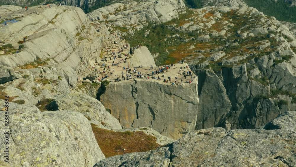 Revealing pan high angle shot of Pulpit rock, people dangerously close ...