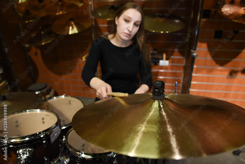 Professional drum set closeup. Beautiful young woman drummer with ...
