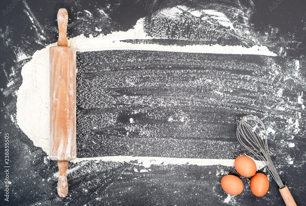 Home baking background with rolling pin flour and eggs on black ...