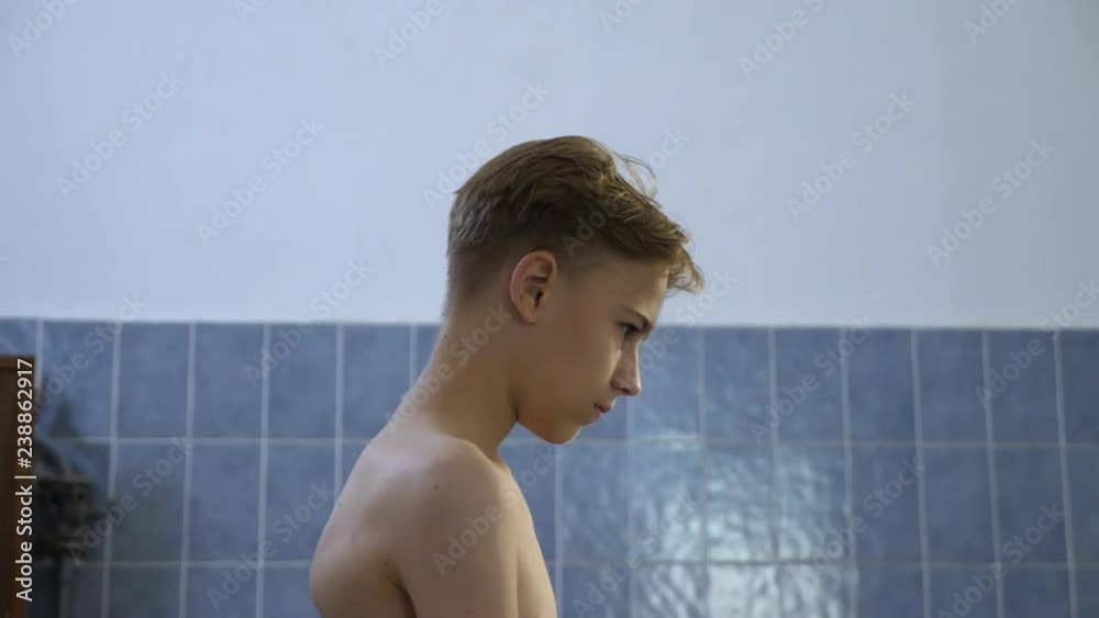 Close up portrait side view of a young teenage boy with blonde hair ...