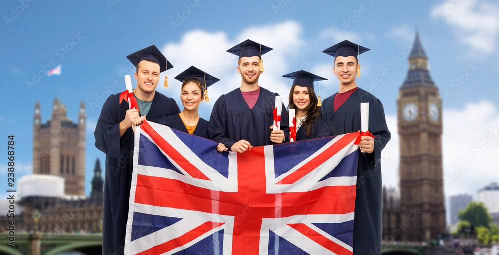 education, graduation and people concept - group of happy graduate ...