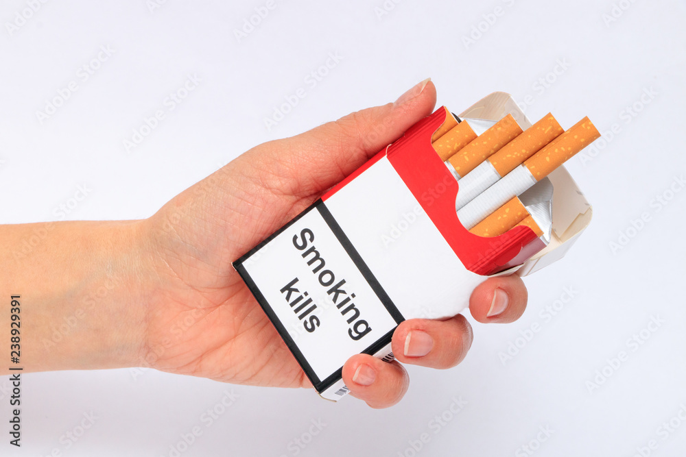 Cigarette box in woman hand Stock Photo | Adobe Stock