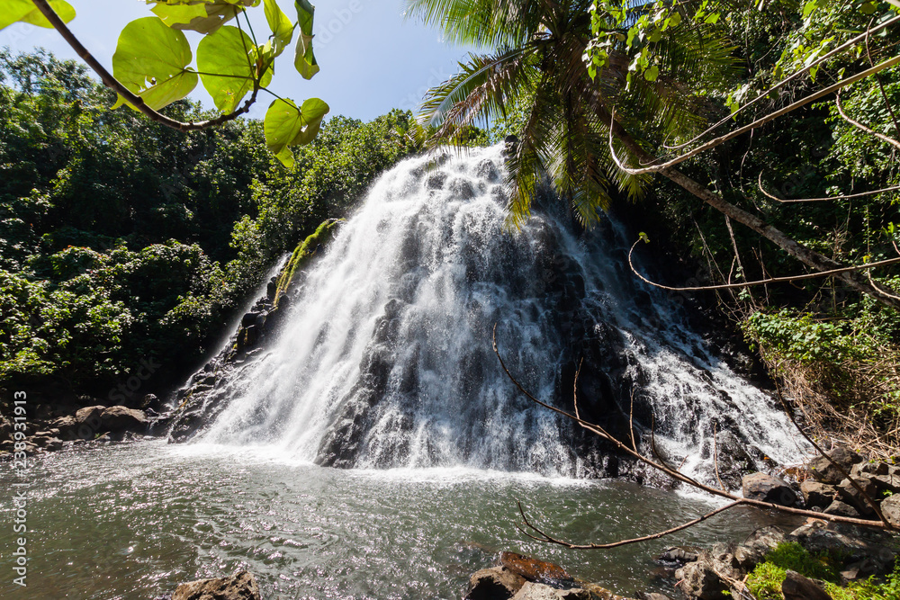 Kepirohi Waterfall in a jungle with palm trees around, near Nan Madol ...