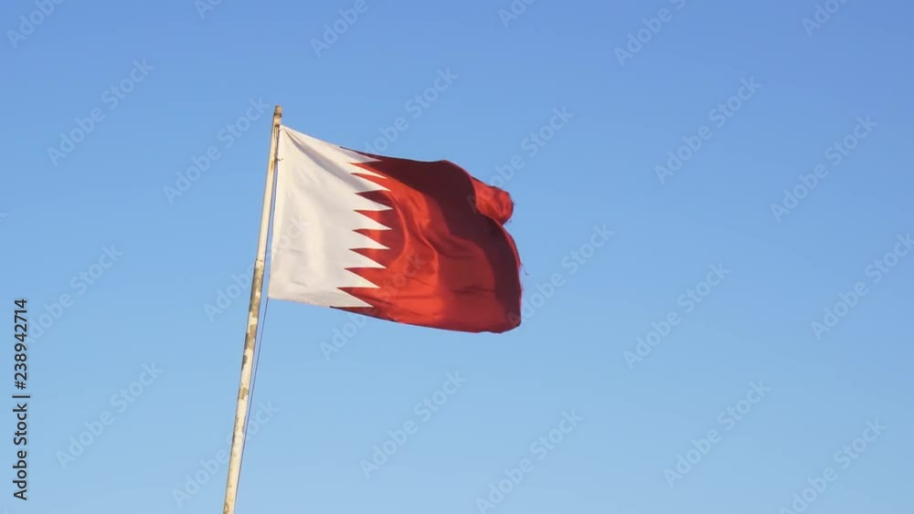 Qatari national flag, with its fields of white and red divided by ...