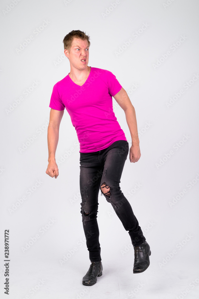 Full body shot of young man making face while farting Stock Photo ...