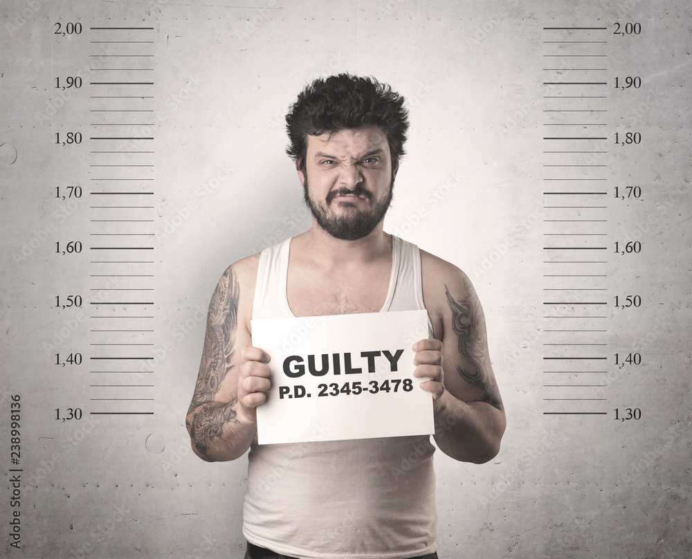 Caught guilty man with ID signs on his hand. Stock Photo | Adobe Stock