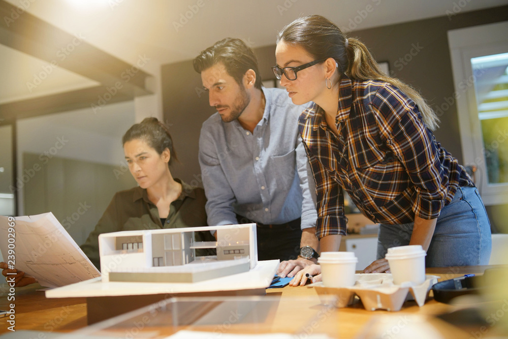 Architects looking over project for modern house design Stock Photo ...