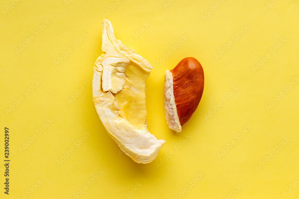 Heart shaped durian on a yellow background, minimal creative food ...
