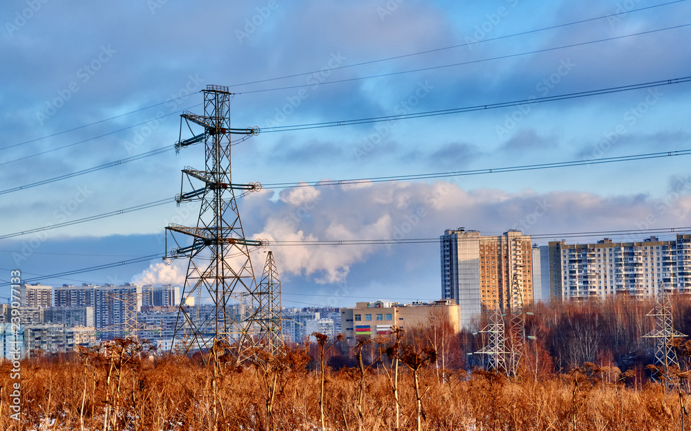Supports of high-voltage power lines, modern houses, roads, Smoking ...