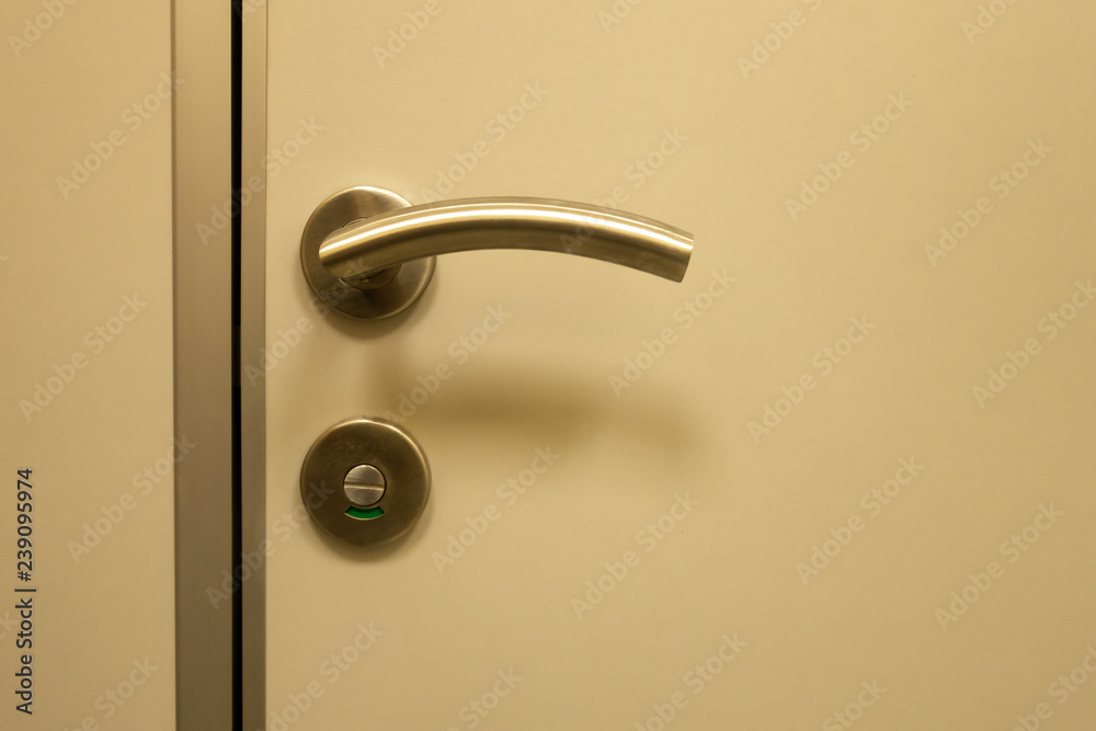 Clean cubicle pee cistern in one company. Clean toilet. Door handle and ...