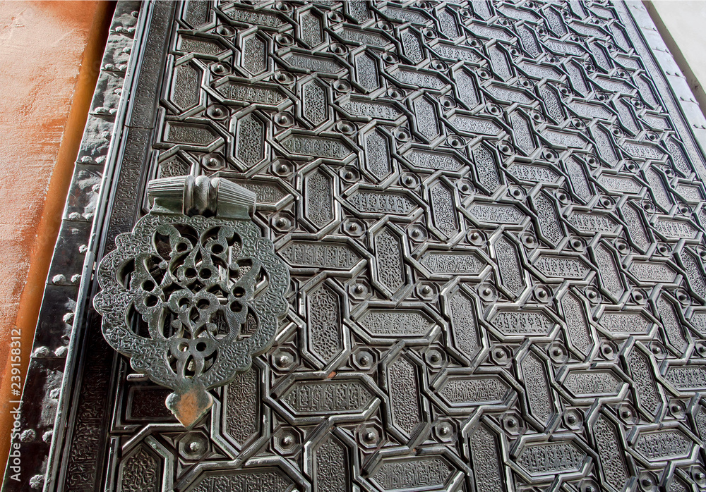 Metal door with islamic patterns and Arabic calligraphy of the 16th ...