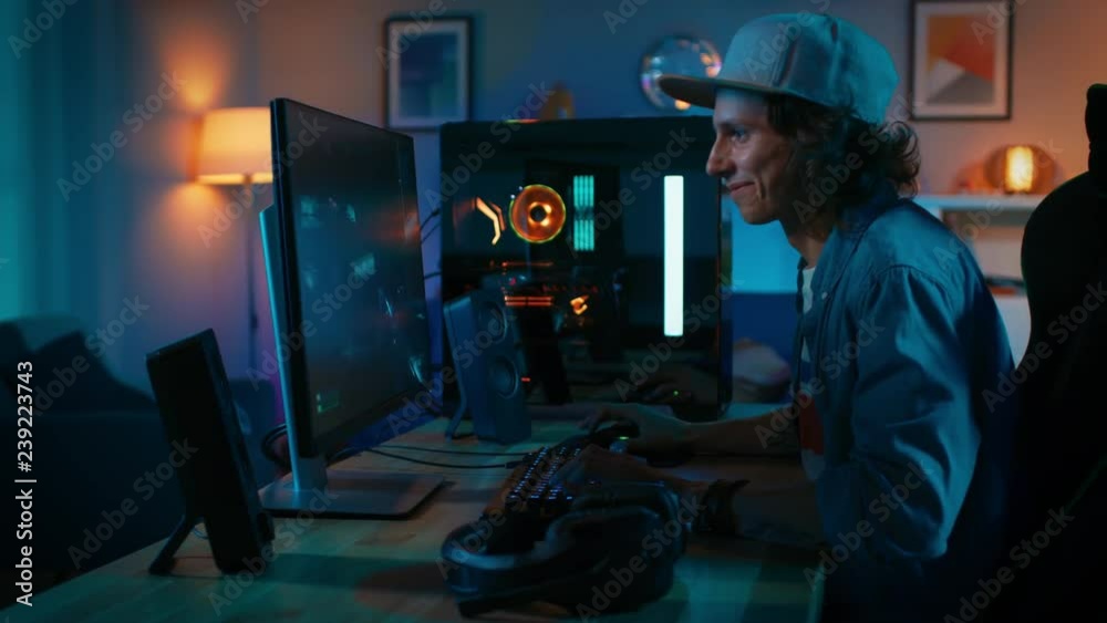 Professional Gamer Playing First-Person Shooter Online Video Game on His Powerful Personal ...