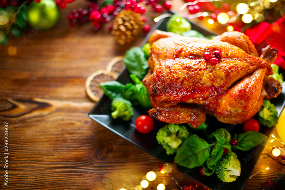 Christmas family dinner. Roasted chicken on holiday served table ...
