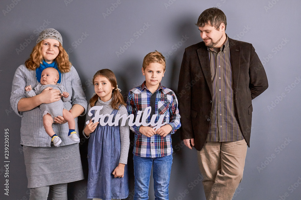 Mother, father and three kids. Mother with infant baby, two senior kids ...