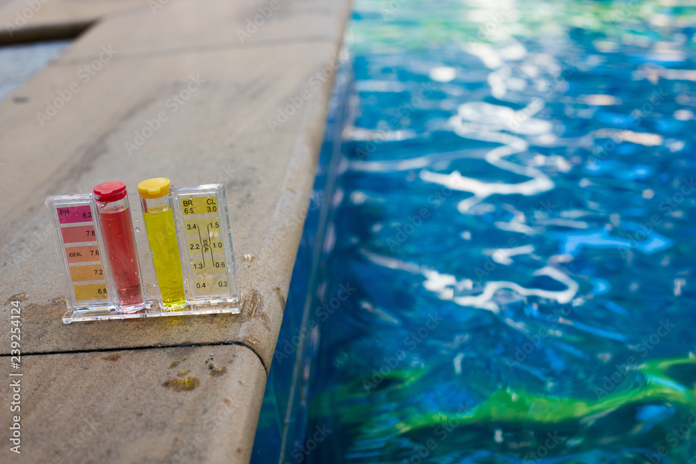PH Test Kit on swim pool river water inspector Photos | Adobe Stock