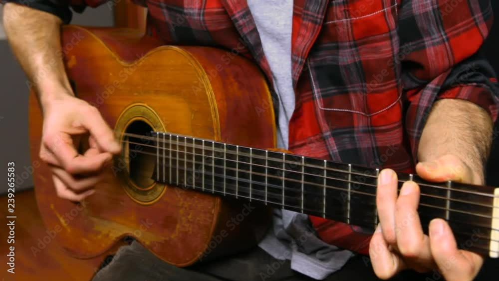 Man fingerpicking on classical guitar. Close up scene, travelling up ...