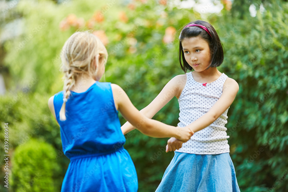Two girls measuring strength Stock Photo | Adobe Stock