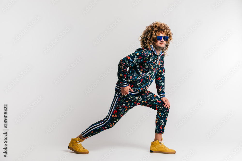 Adult positive smiling funky man with curly hair style in suglasses and ...