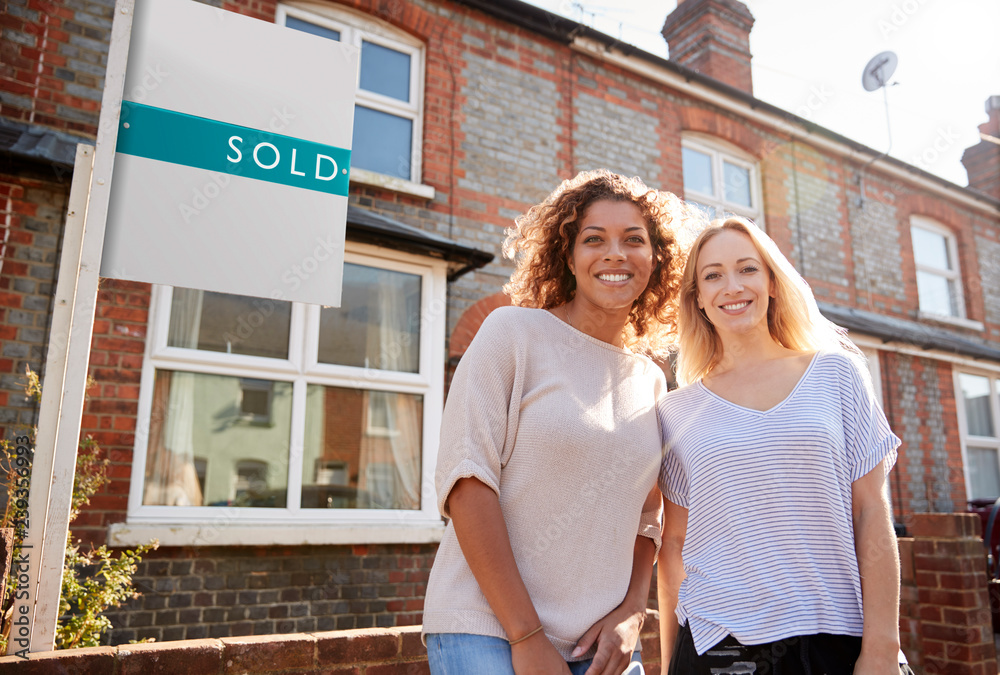Portrait Of Two Women Standing Outside New Home With Sold Sign Stock ...