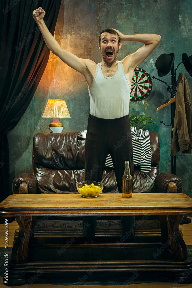 Winner. Overwhelmed cheerful man moving hands while celebrating the ...