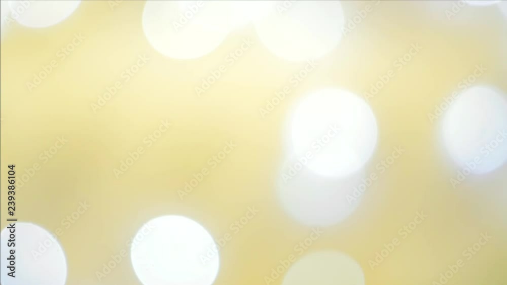 Abstract smooth white and silver bokeh lights on defocused bright yellow background. Bokeh ...