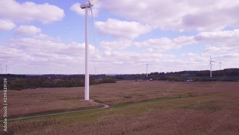 Aerial view of wind turbine creating green and renewable energy. Camera ...