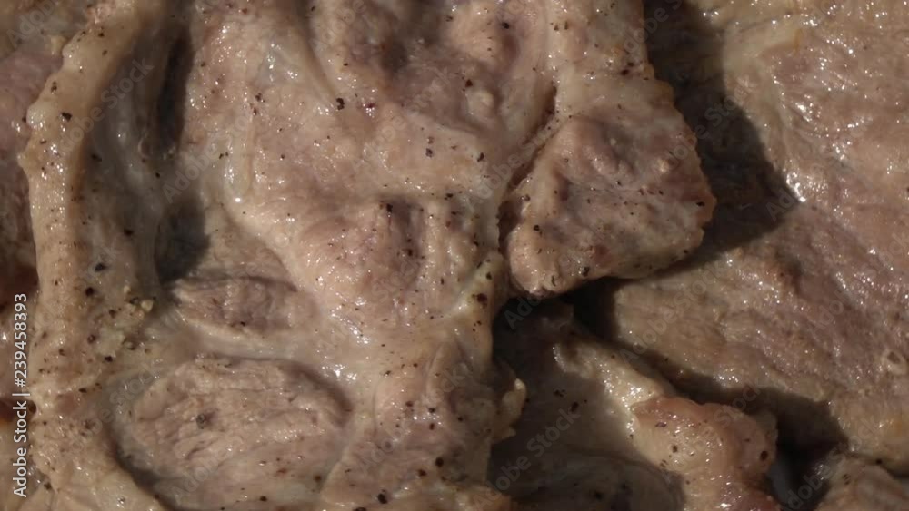 Freshly roasted pork steaks, rotating close up. Appetizing natural food ...
