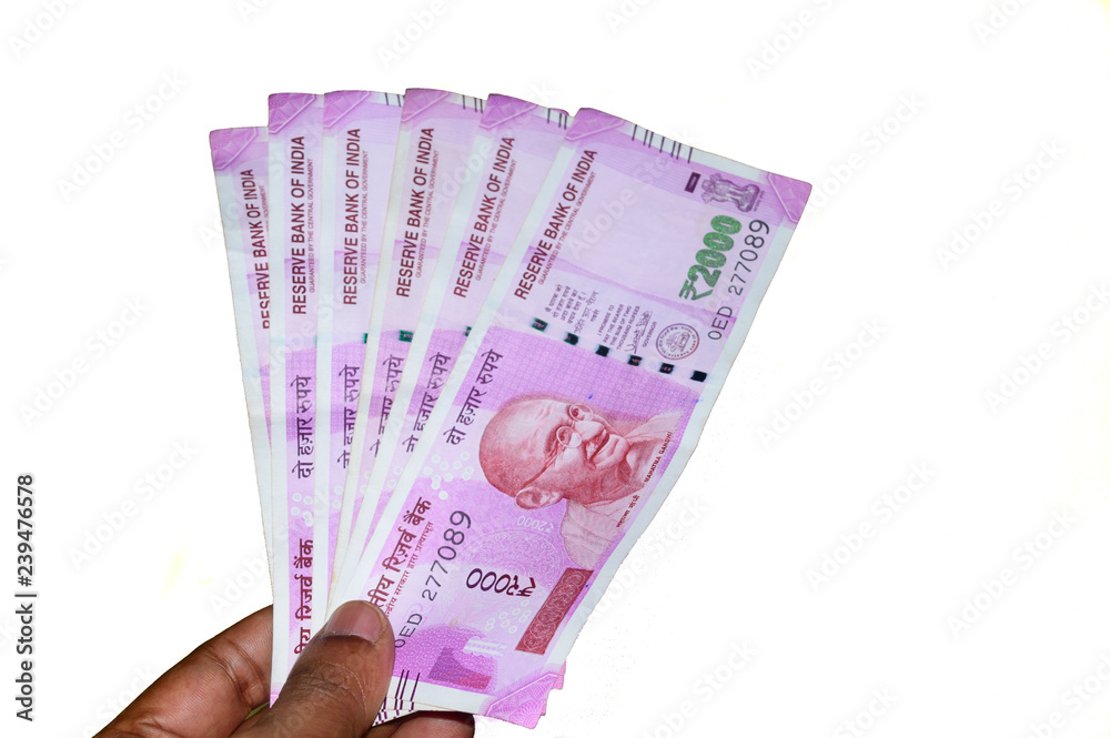 Selective Focus: Hand holding Indian 2000 rupee notes against white ...
