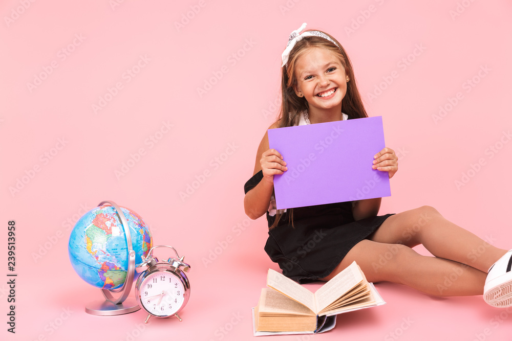 Lovely little girl wearing dress studying Stock Photo | Adobe Stock