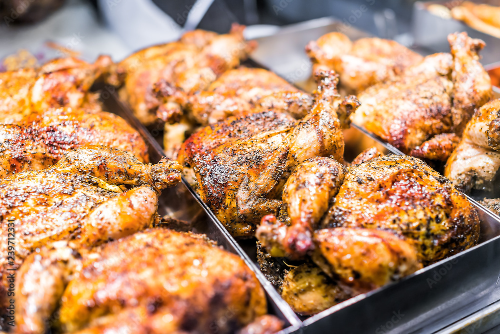 Many whole chicken roasted closeup on tray in deli display store shop ...