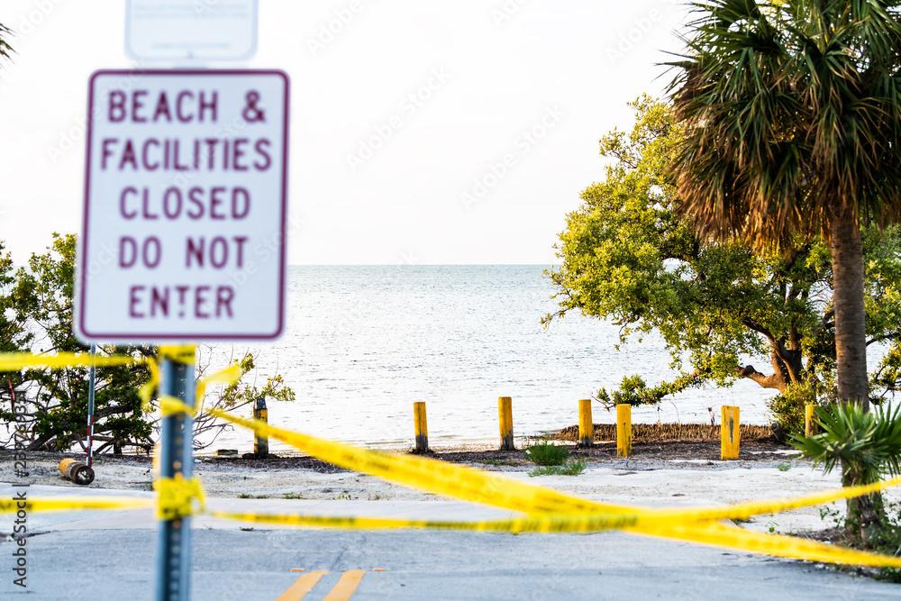 Beach, facilities closed, do not enter sign post by coast, shore after ...